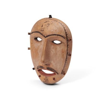 Bonhams Skinner : An Eskimo wood face mask, 8 3/4 x 6 in.