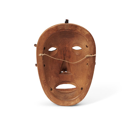 Bonhams Skinner : An Eskimo wood face mask, 8 3/4 x 6 in.