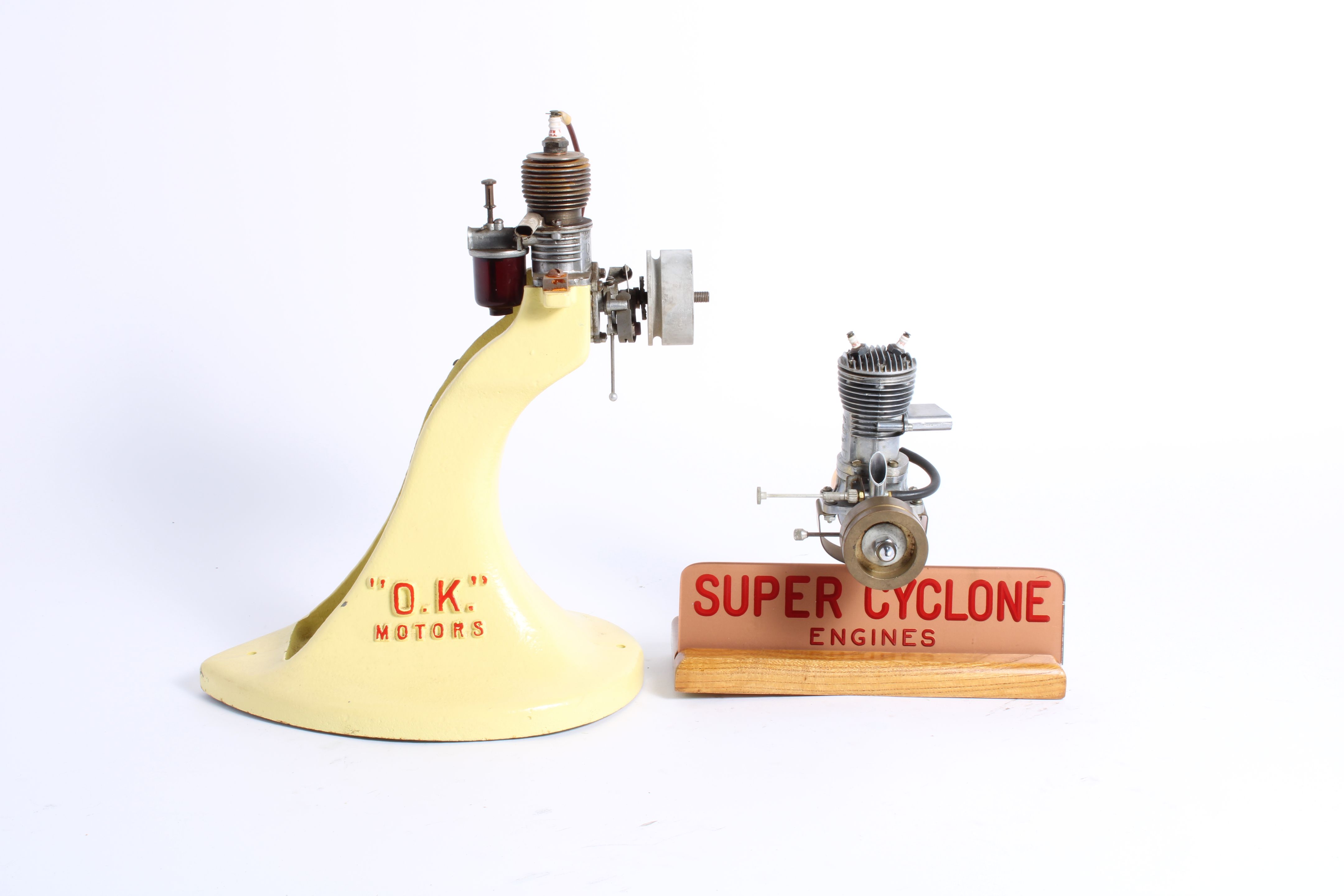 Bonhams Cars : Two miniature model engines on shop display stands, (2)