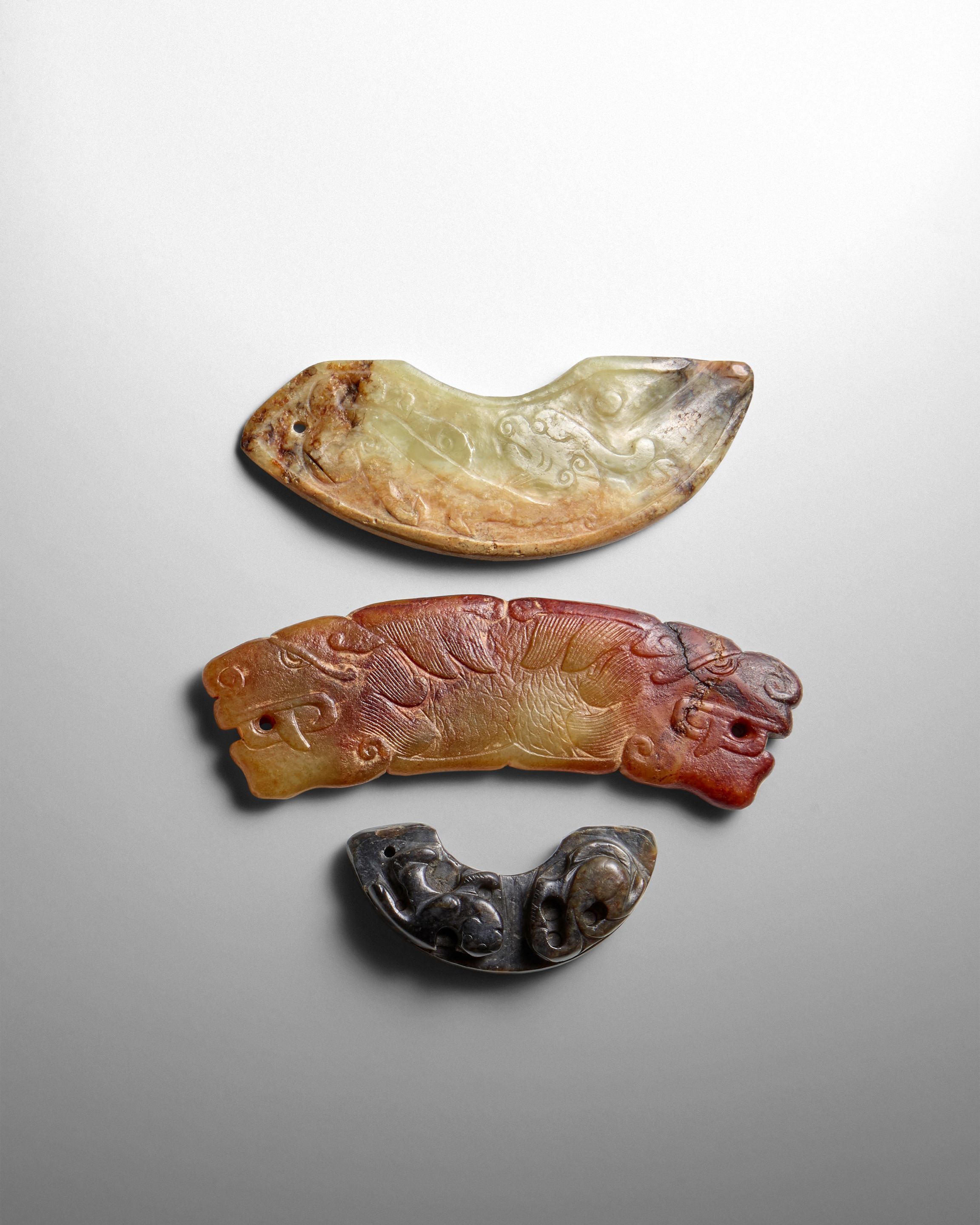 Bonhams : THREE ARCHAISTIC JADE HUANG PENDANTS Late Qing Dynasty