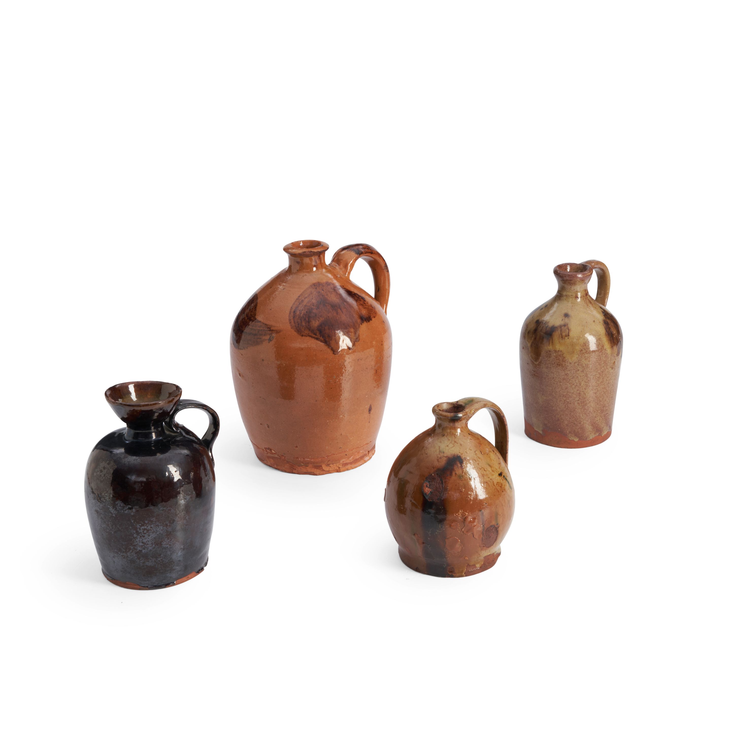 Bonhams Skinner : Four Glazed Redware Jugs, New England, 19th century.